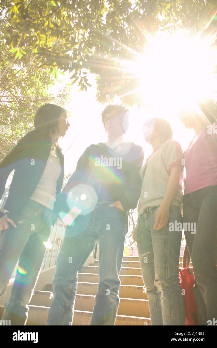 Four college students talking Stock Photo - Alamy