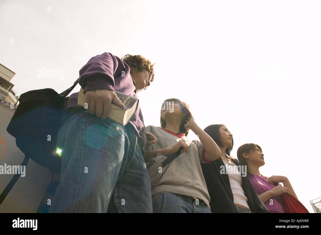 Four college students talking Stock Photo - Alamy