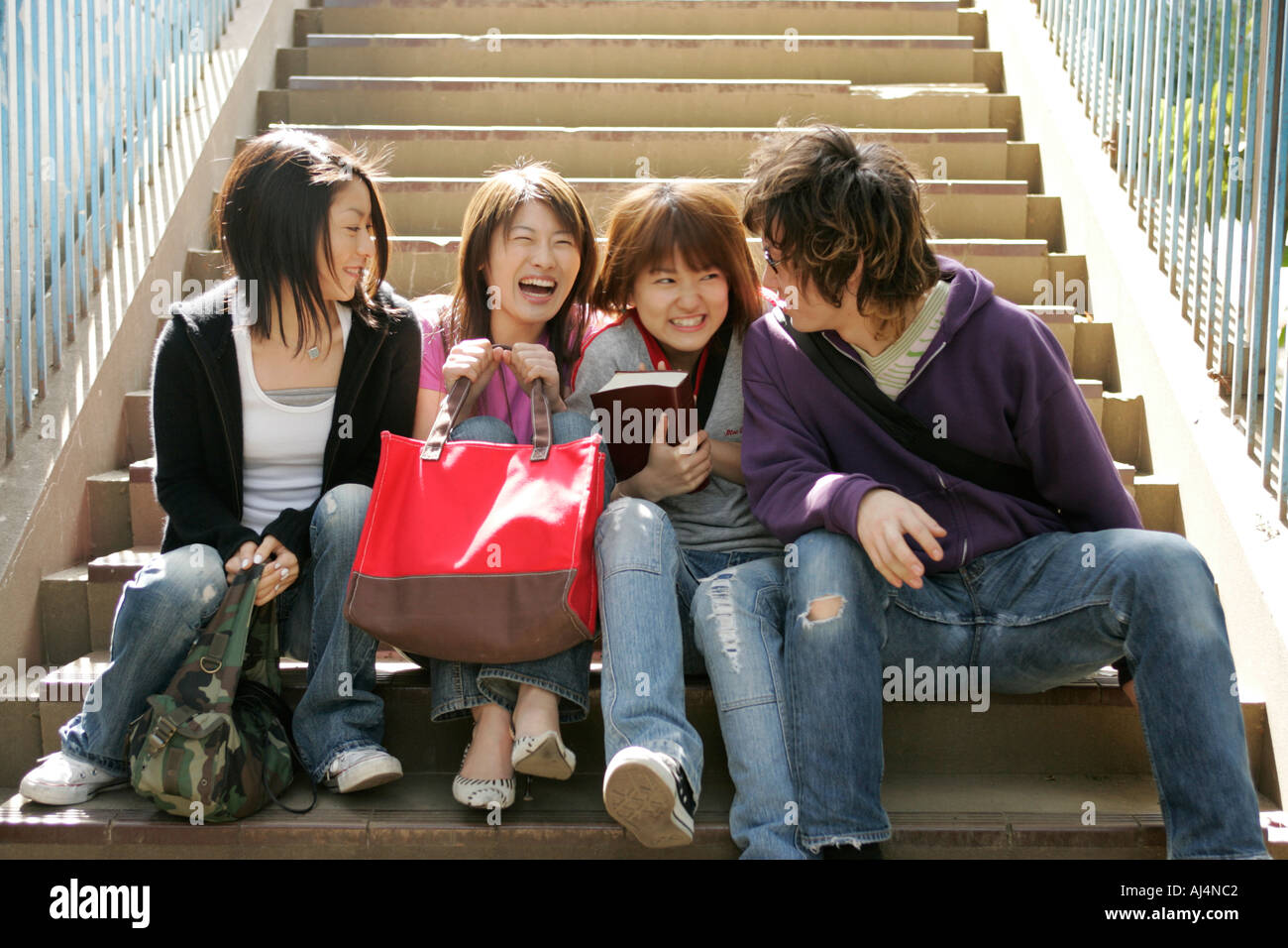 Four college students talking Stock Photo - Alamy