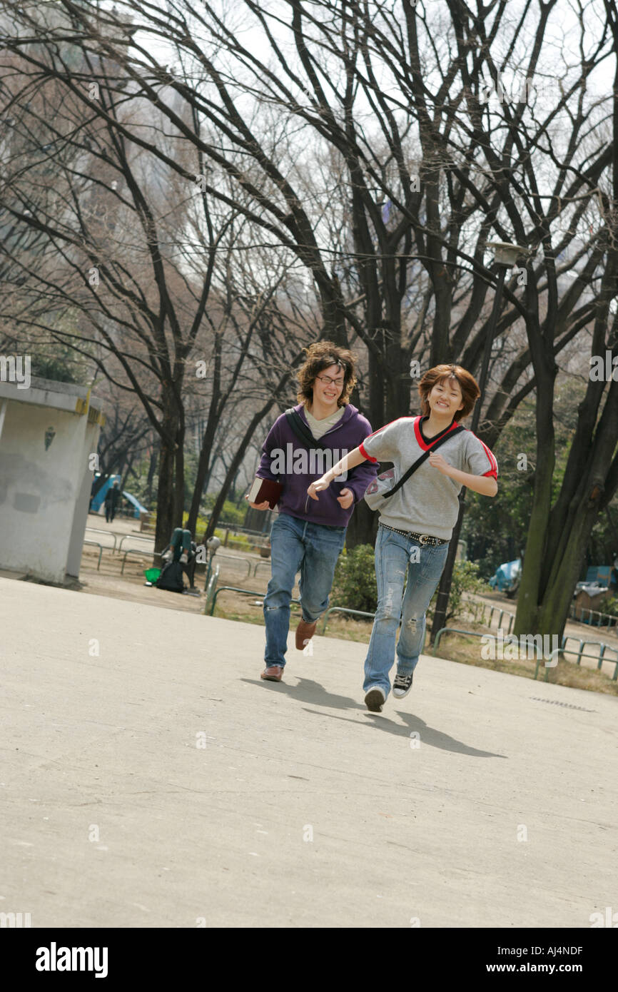 Two college students running Stock Photo - Alamy