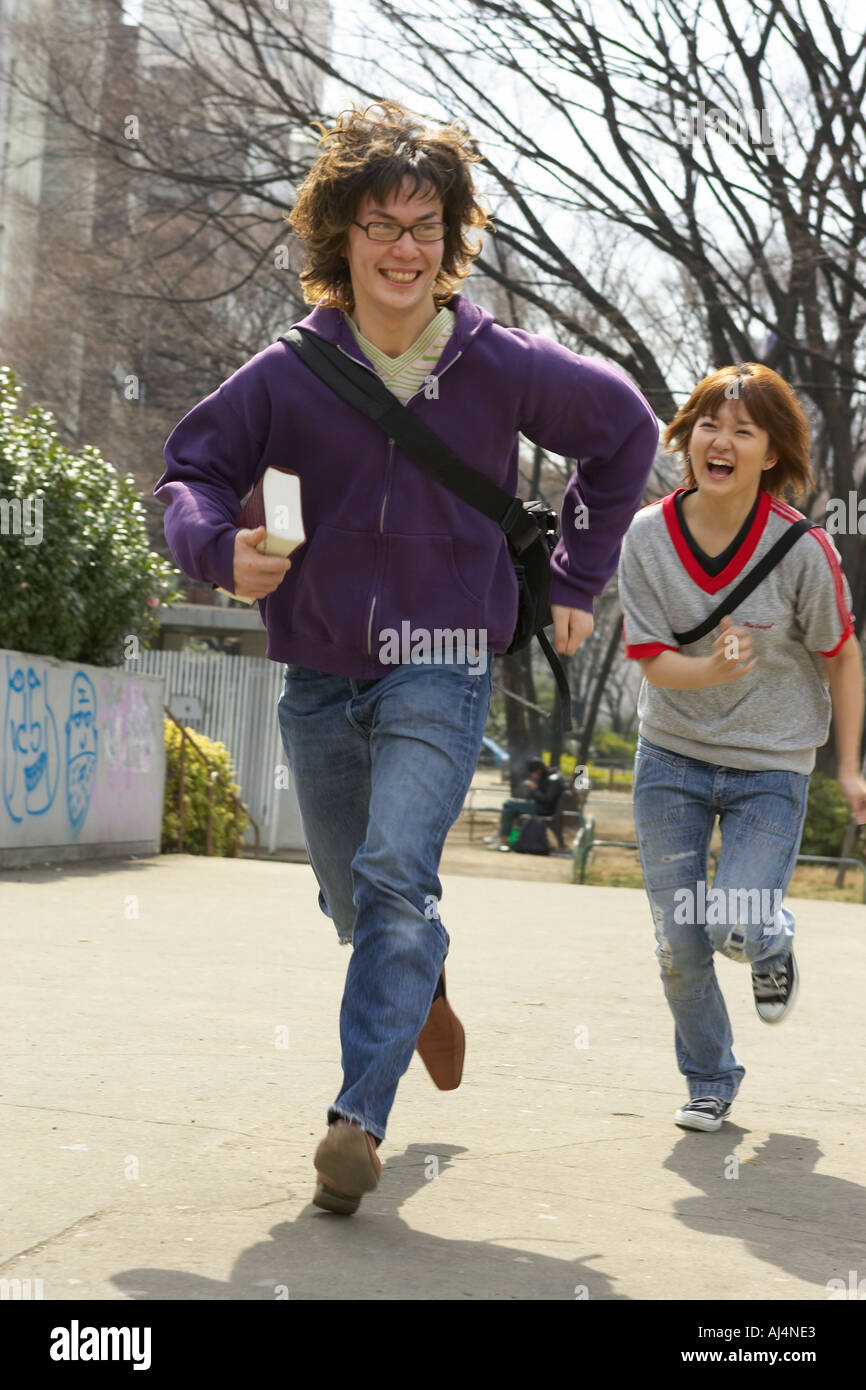 Two college students running Stock Photo - Alamy