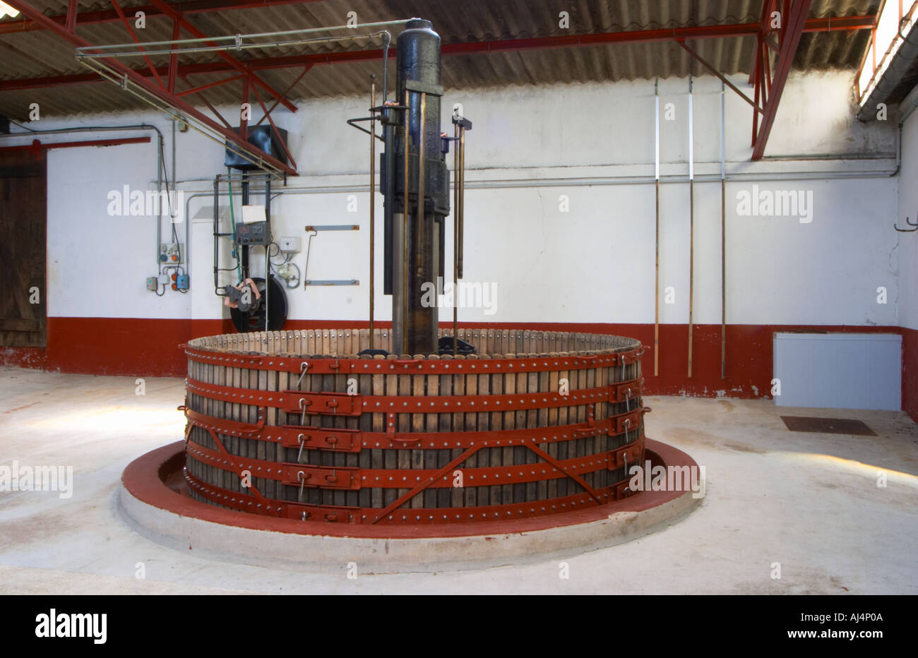 In the winery: a traditional, round, vertical, basket wine press with ...