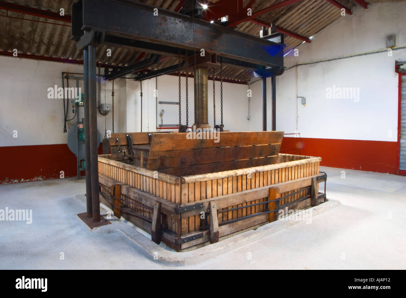 In the winery: a traditional, square, vertical, basket wine press with ...