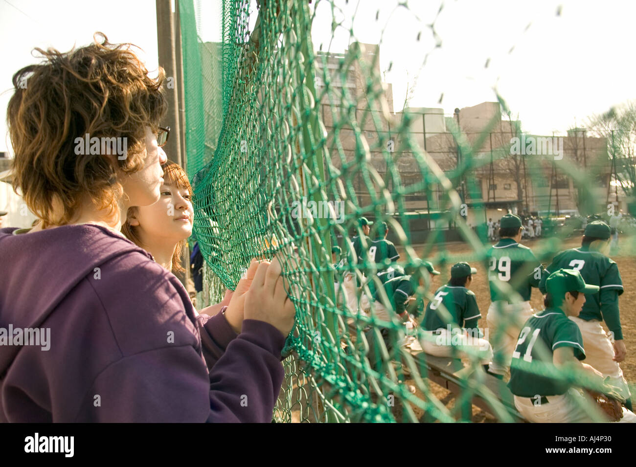 Two college students watching baseball game Stock Photo - Alamy