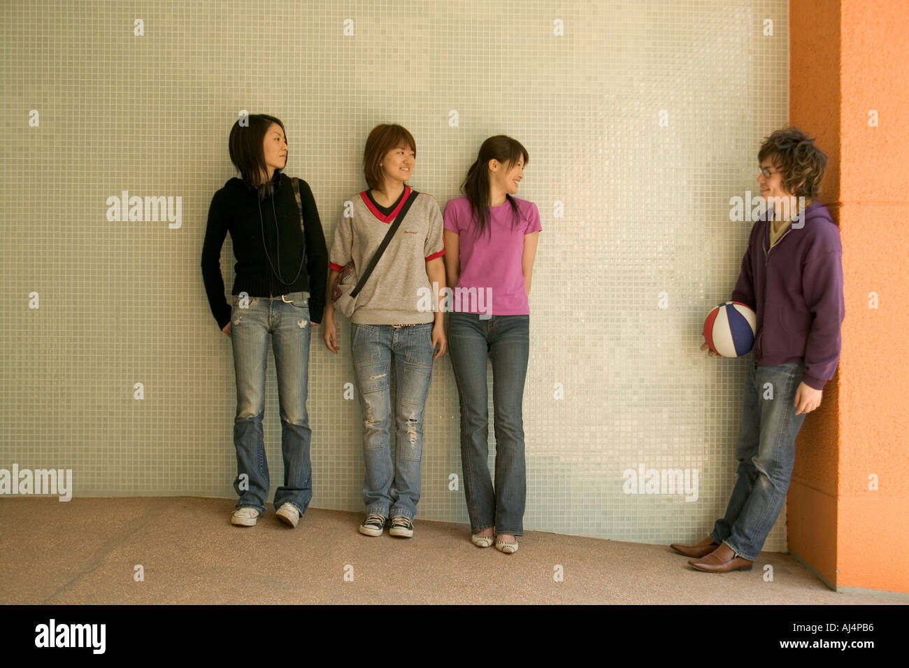 Four college students talking Stock Photo - Alamy
