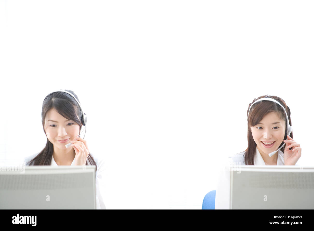 Two business people wearing headsets hi-res stock photography and ...
