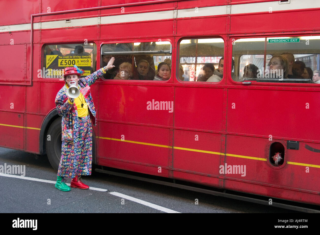 Clown in Oxford Street attracting attention London UK Stock Photo - Alamy