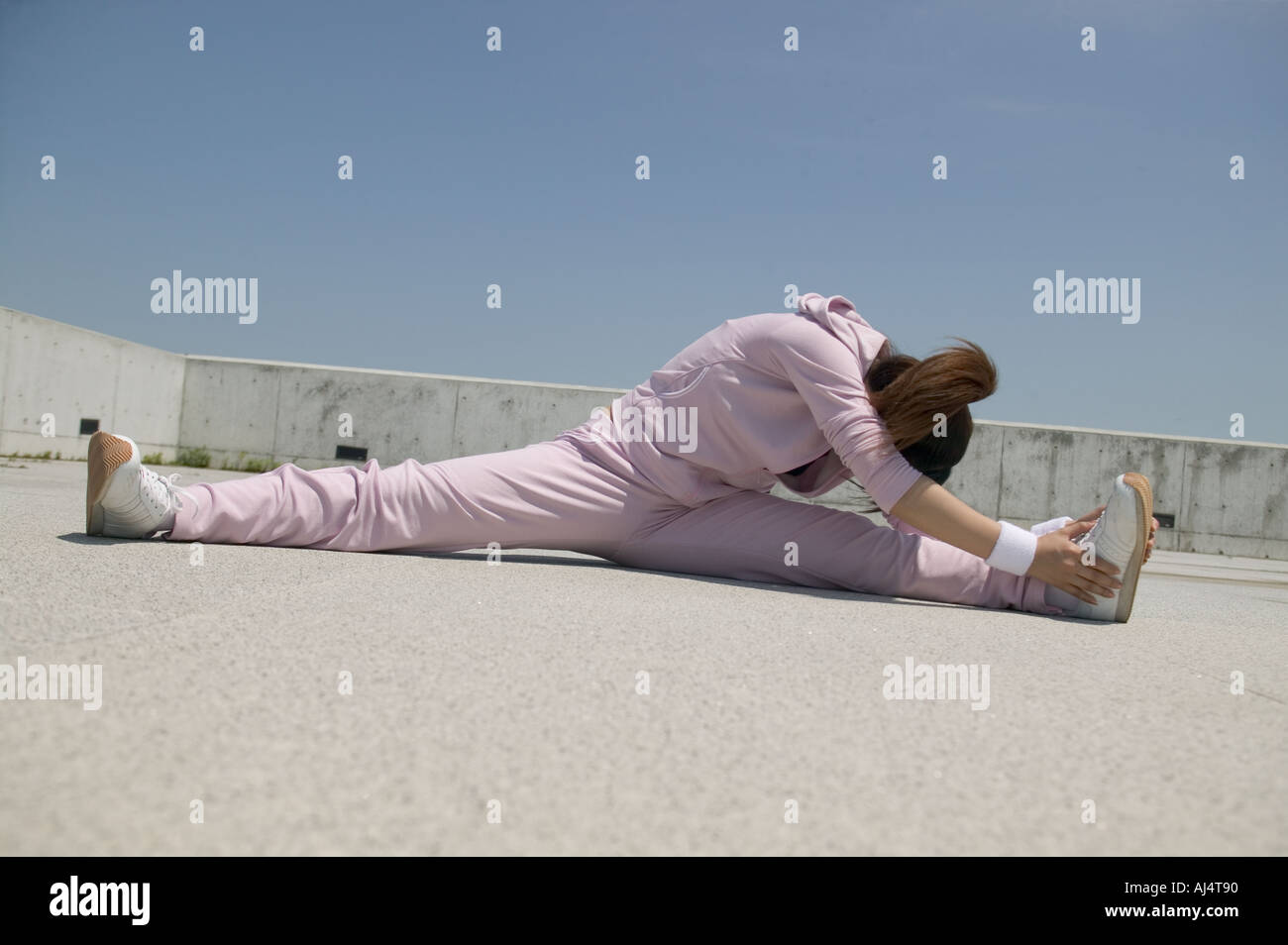 Woman stretching legs doing splits hi-res stock photography and images ...