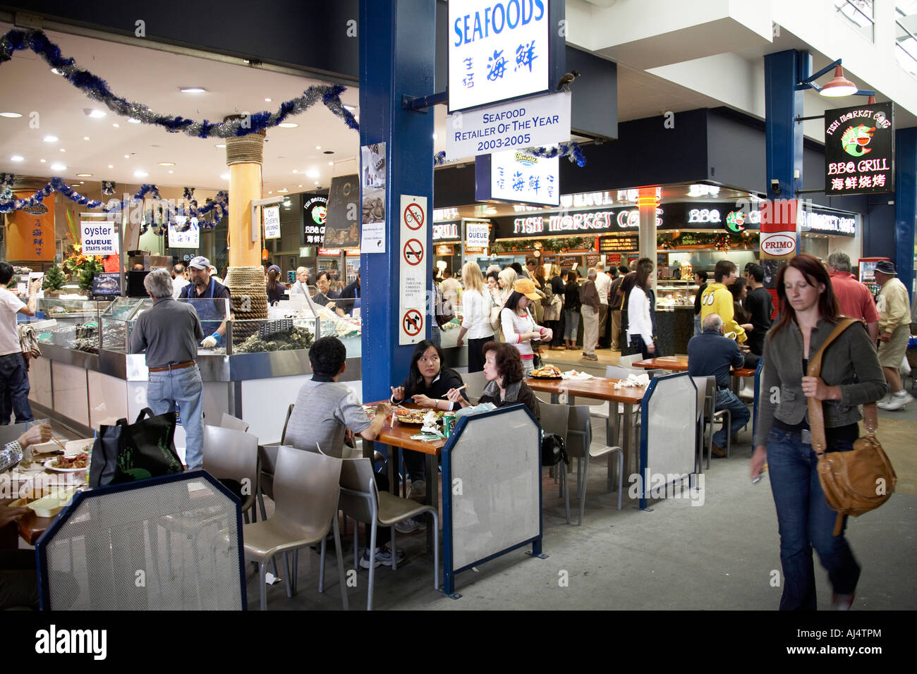 Seafood restaurant with people dining and eating in Fish Market Sydney ...