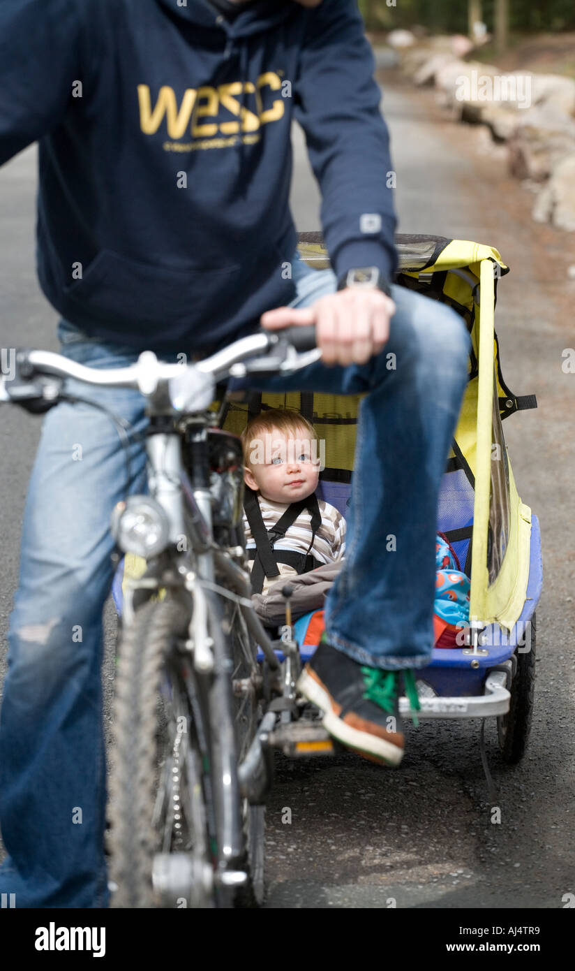 A young boy being transported in a cycle trailer England UK Stock Photo ...