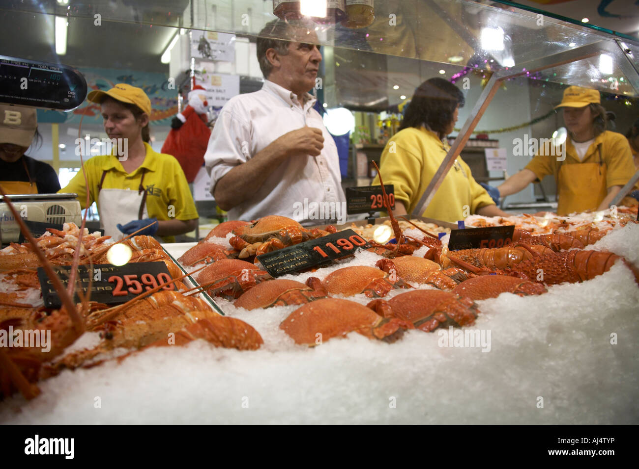Staff with fish on sale in Fish Market shop Sydney New South Wales NSW ...