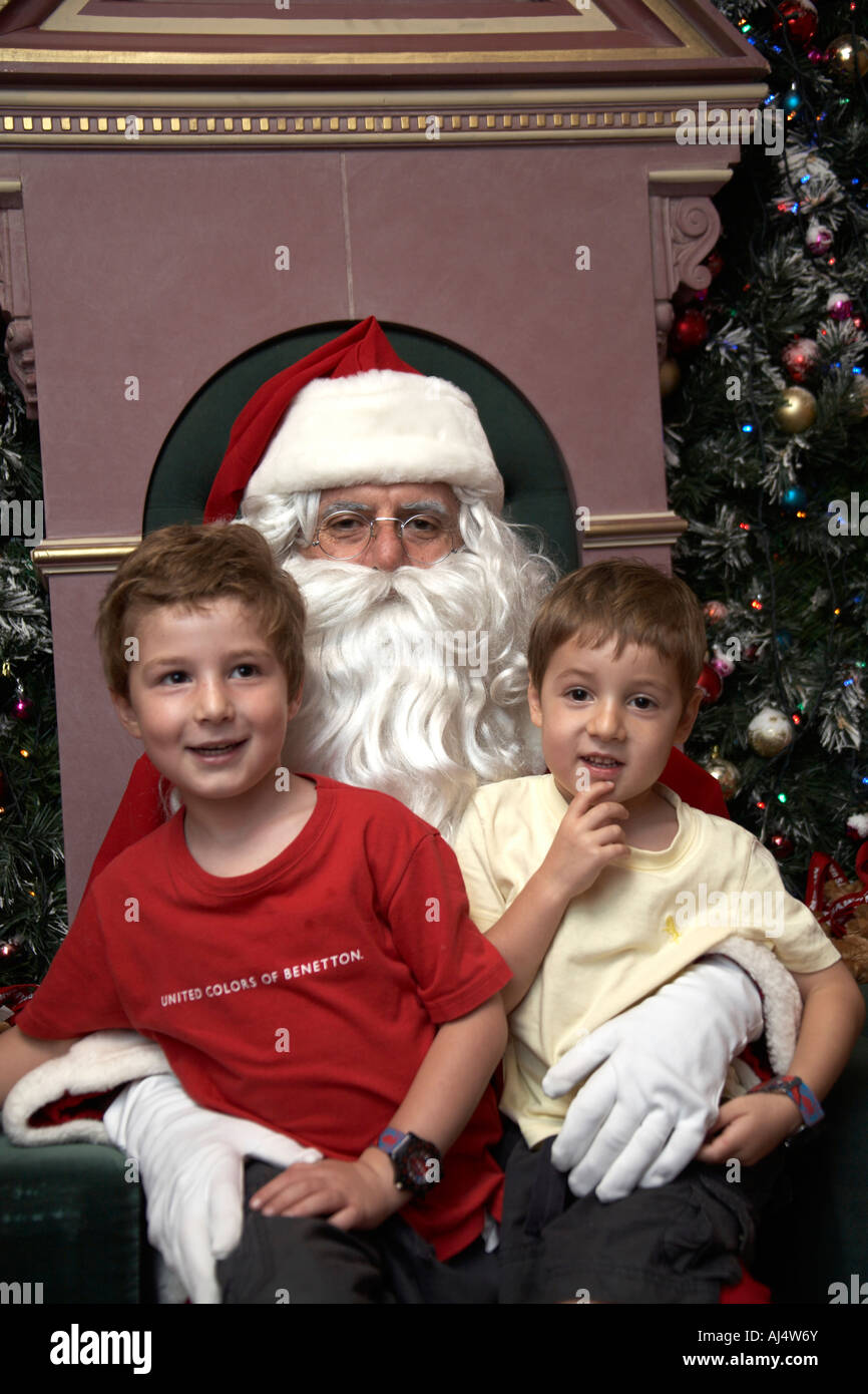 Father Christmas or Santa Claus with red hat white beard and two young ...