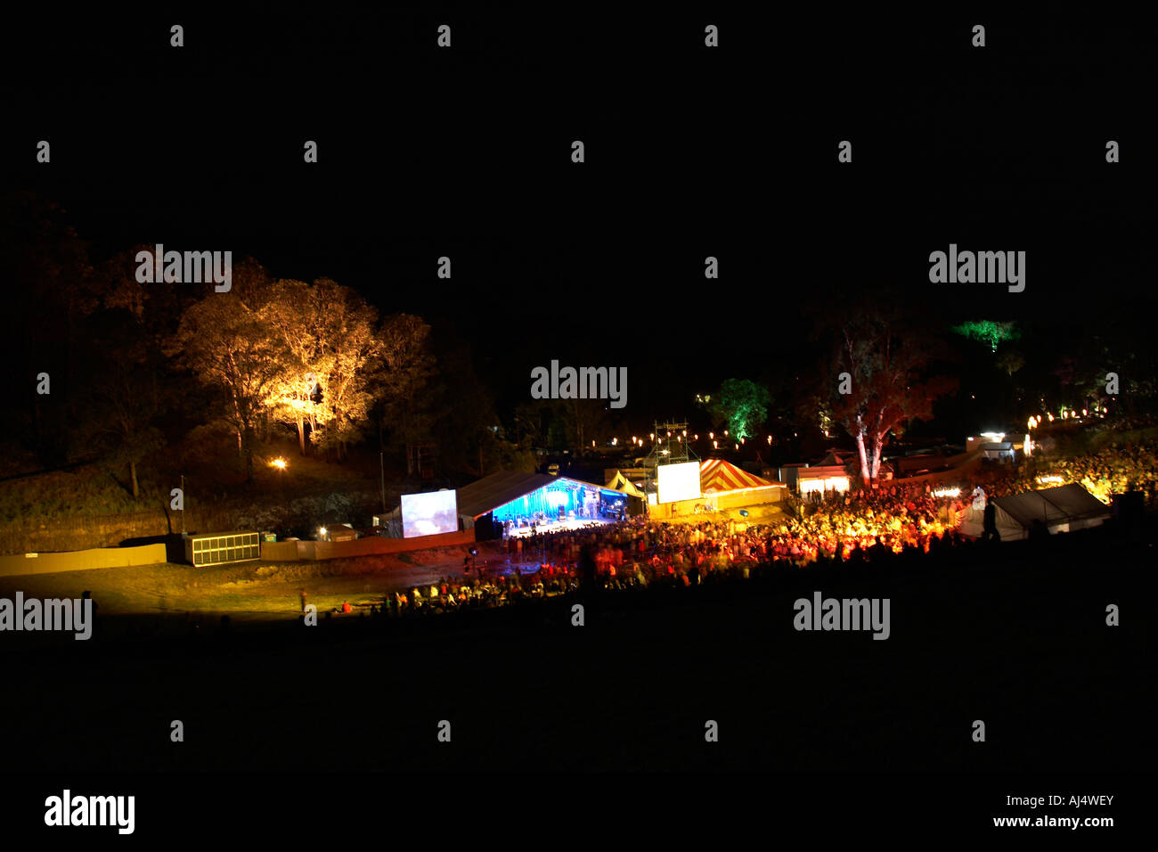 Trees around stage night lit by coloured lights by Walter Holt and ...