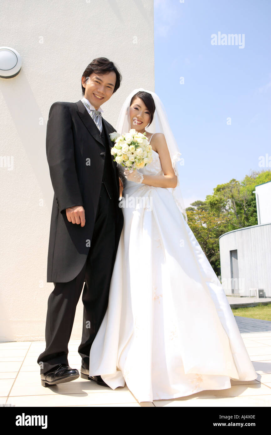 Bride and groom looking at camera Stock Photo - Alamy