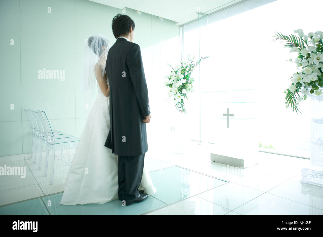 Rear view of bride and groom at altar Stock Photo - Alamy