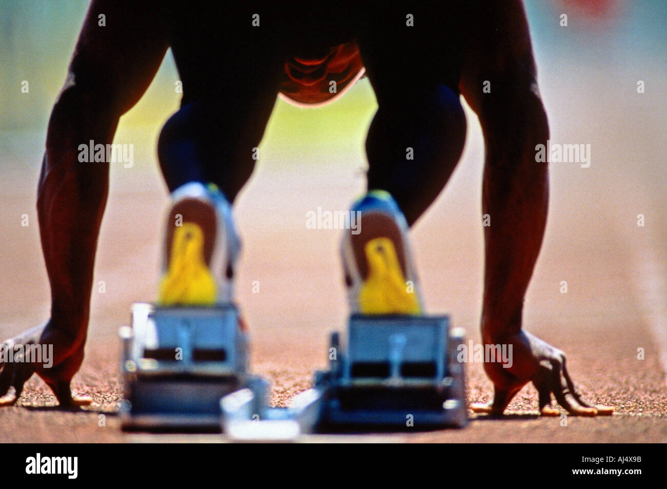Sprinter in the starting blocks Stock Photo - Alamy