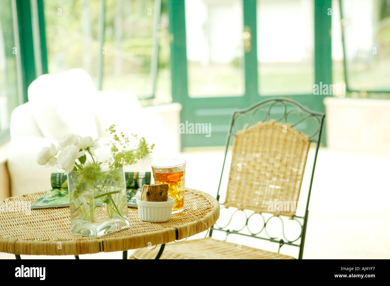 Table and chair in conservatory Stock Photo - Alamy
