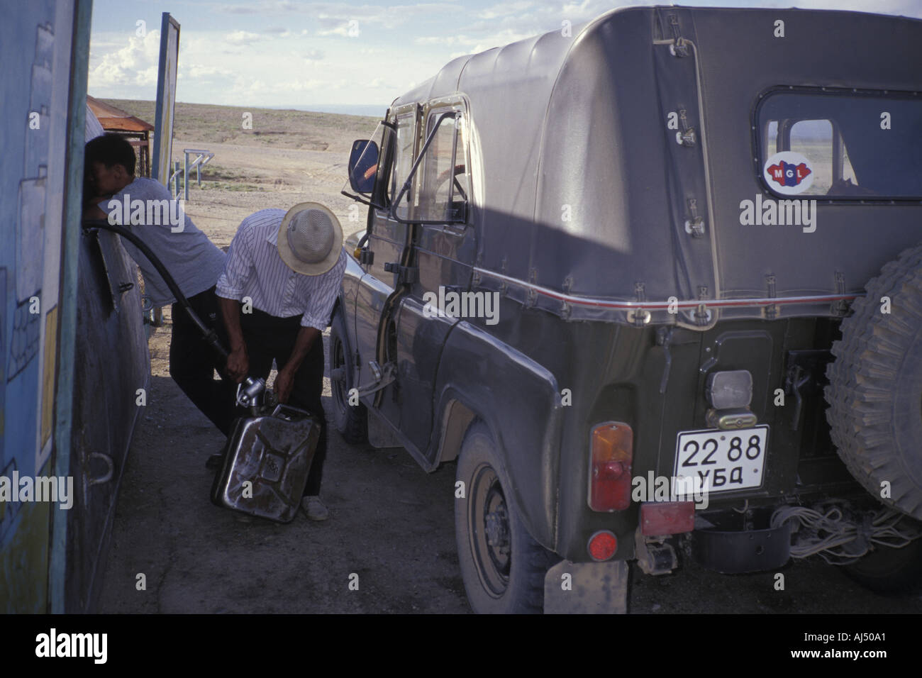 Filling up with petrol at the last petrol station to cross the the Gobi ...