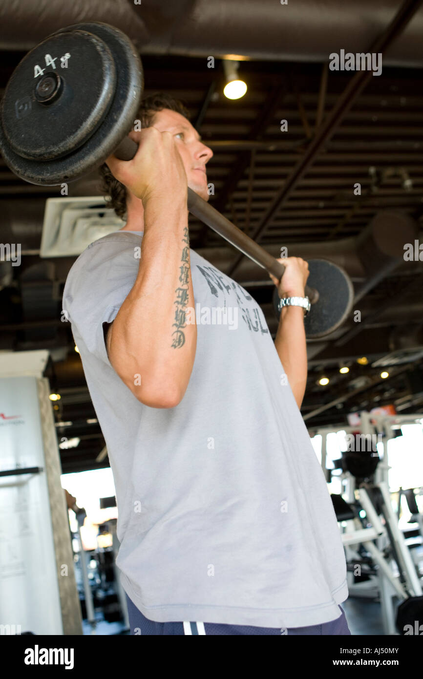 Fit male exercising in a gym arm bicep workout Stock Photo - Alamy