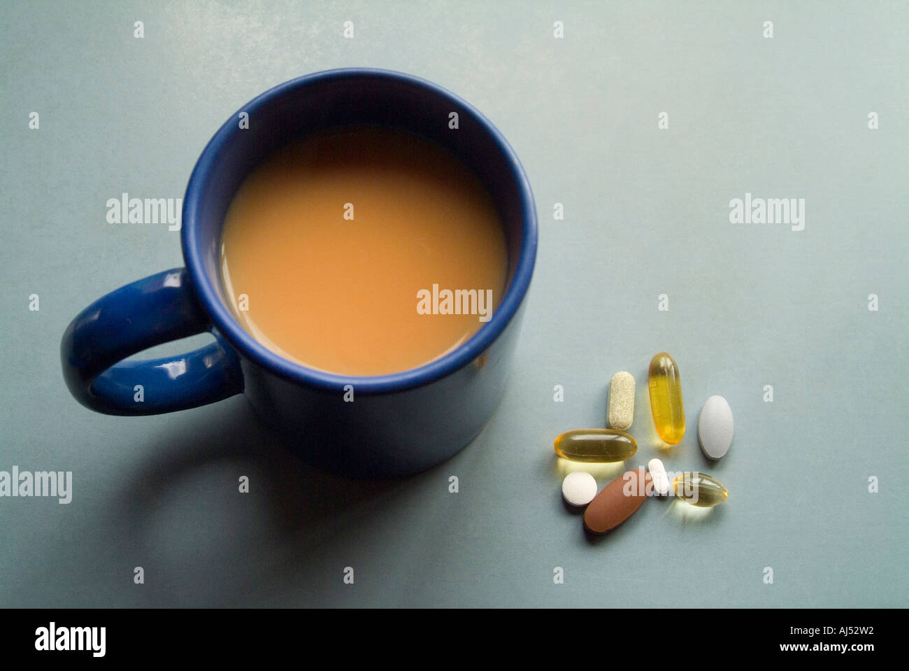 Vitamin pills capsules and medication with a cup of tea Stock Photo - Alamy
