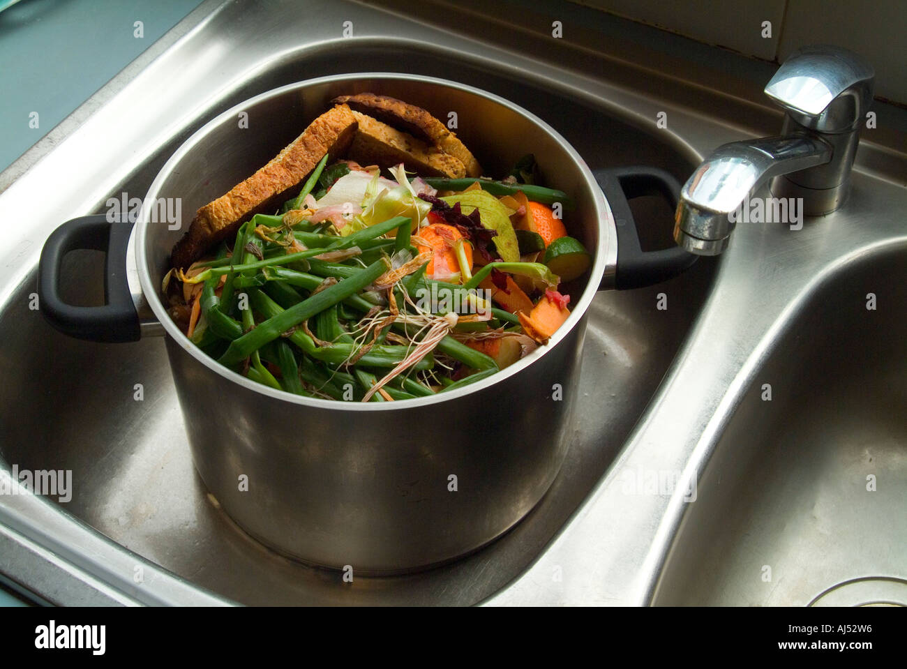 A mixture of kitchen scraps in a saucepan for composting, feeding a ...
