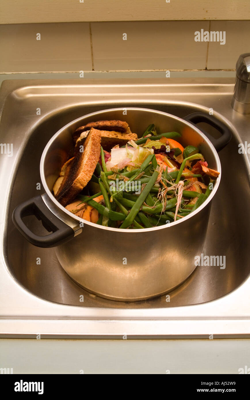 A mixture of kitchen scraps in a saucepan for composting, feeding a ...
