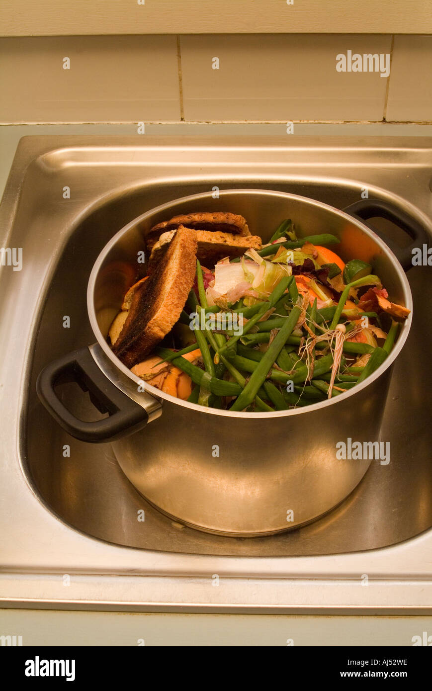 A mixture of kitchen scraps in a saucepan for composting, feeding a ...