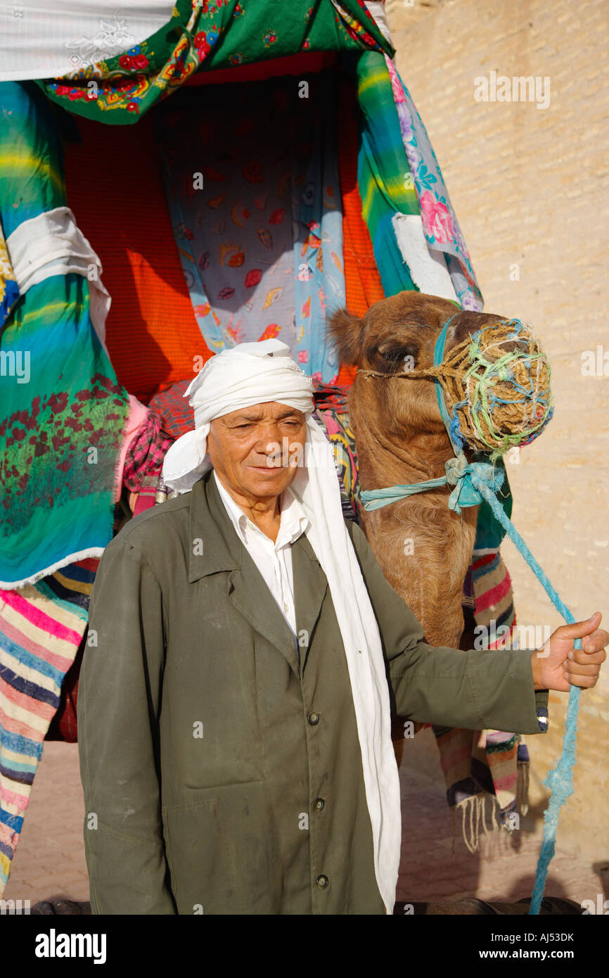 Camel and owner, waiting to be photographed with tourists, Tunisia ...