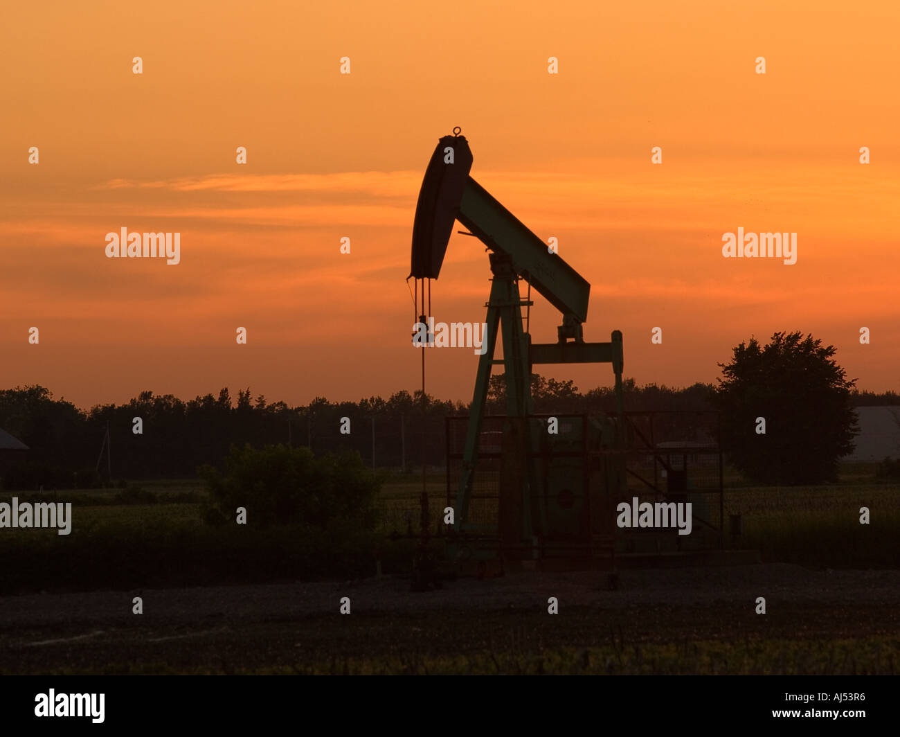 Oil Derrick pumping crude oil Stock Photo - Alamy