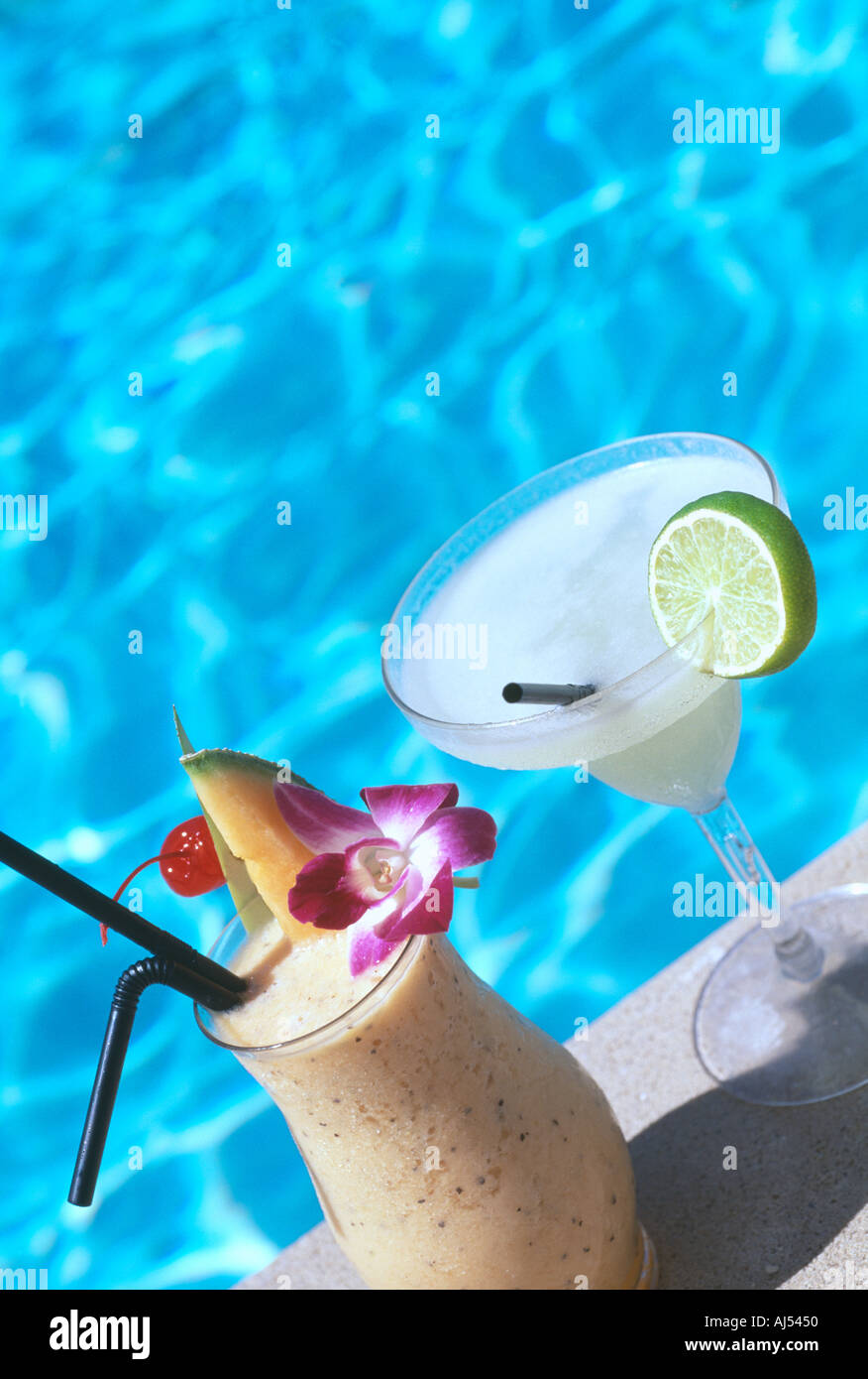Cocktails by the swimming pool holiday image Stock Photo - Alamy