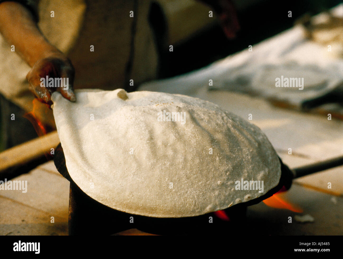 Indian nan bread is baked on a traditional stove Stock Photo - Alamy