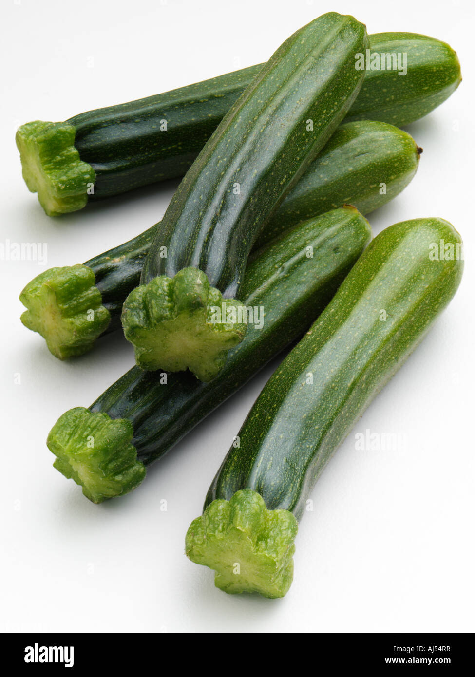 Baby courgettes on a white background Stock Photo - Alamy