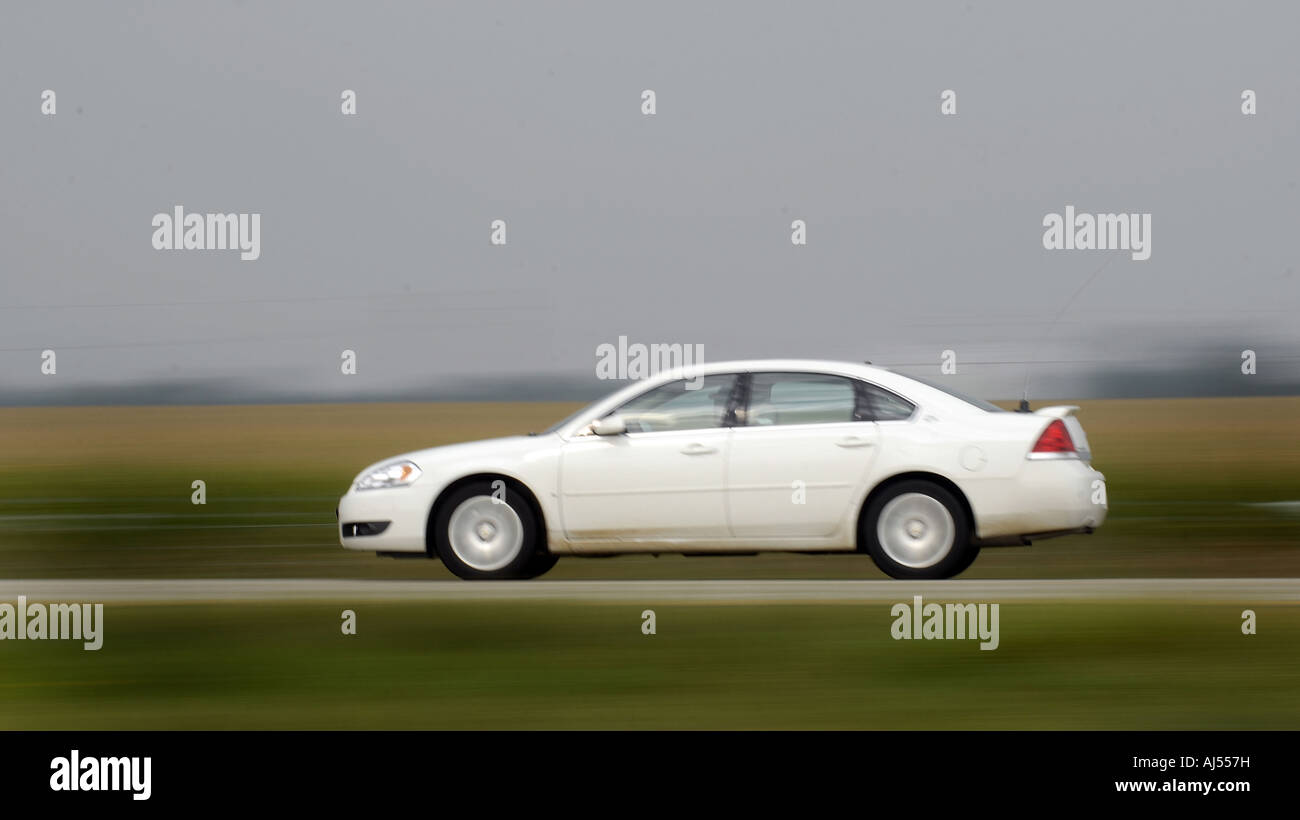 A car speeding on a rural road Stock Photo - Alamy