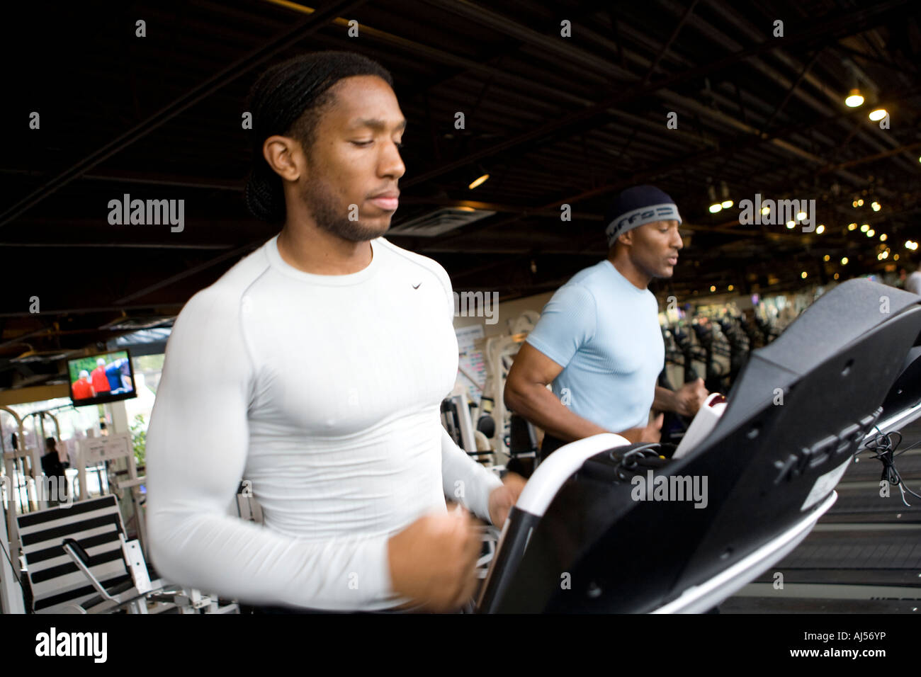 two 2 fit fitness males men exercising in a gym chest bench press ...