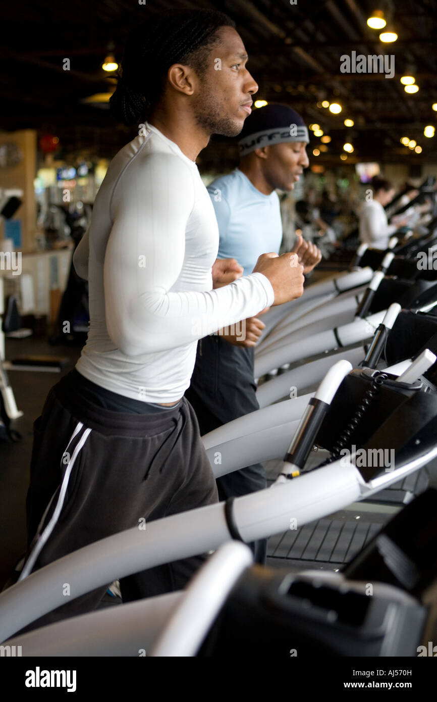 two 2 fit fitness males men exercising in a gym chest bench press ...