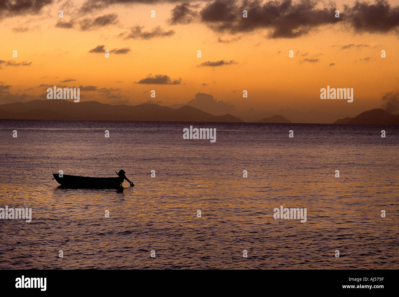 BVI Cooper Island dinghy floats on stern of anchored boat at sunset ...