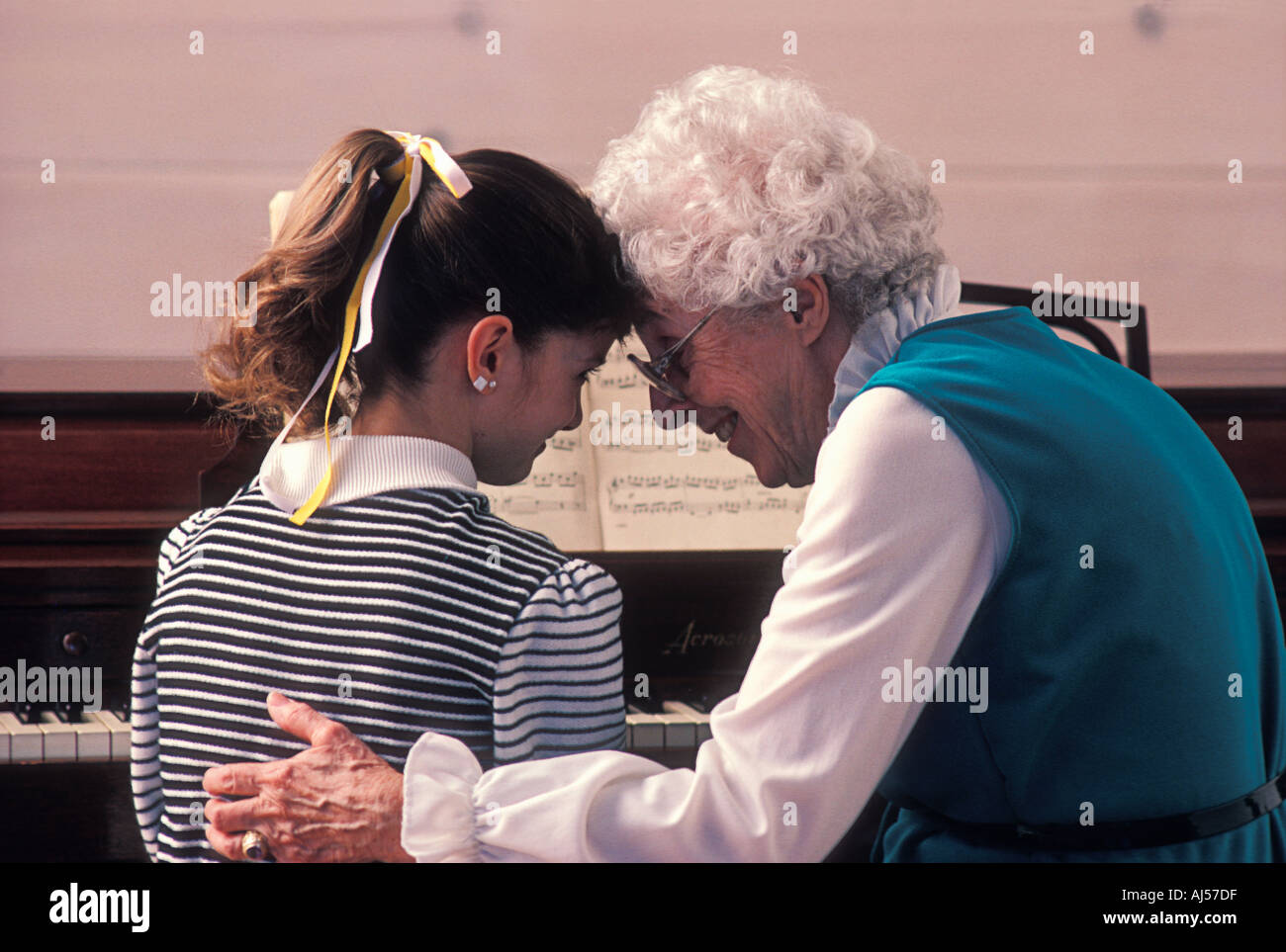 Grandmother teaching granddaughter to play the piano Stock Photo - Alamy