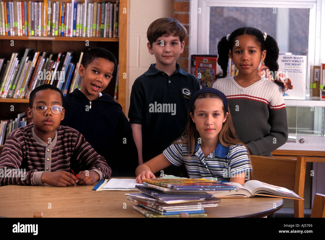Portrait of multiracial group of students in elementary school library ...