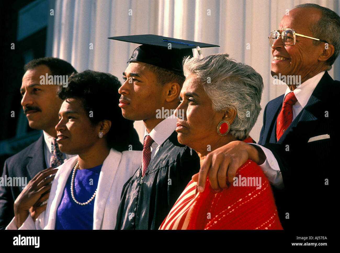 Three generations African American family celebrating sons graduation ...