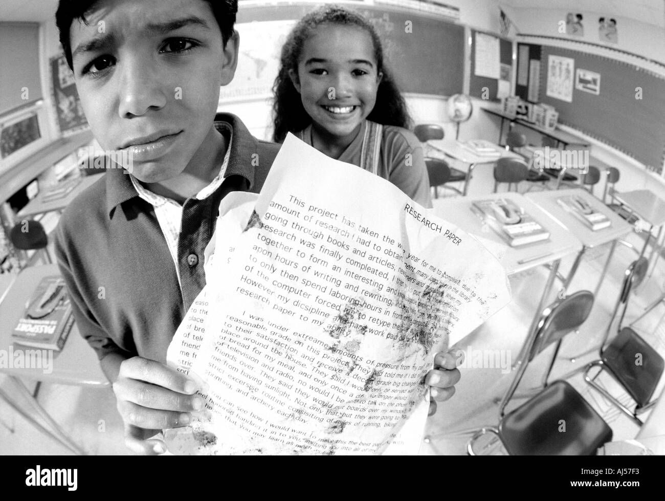 Black and white worried Latino male student handing teacher very messy ...