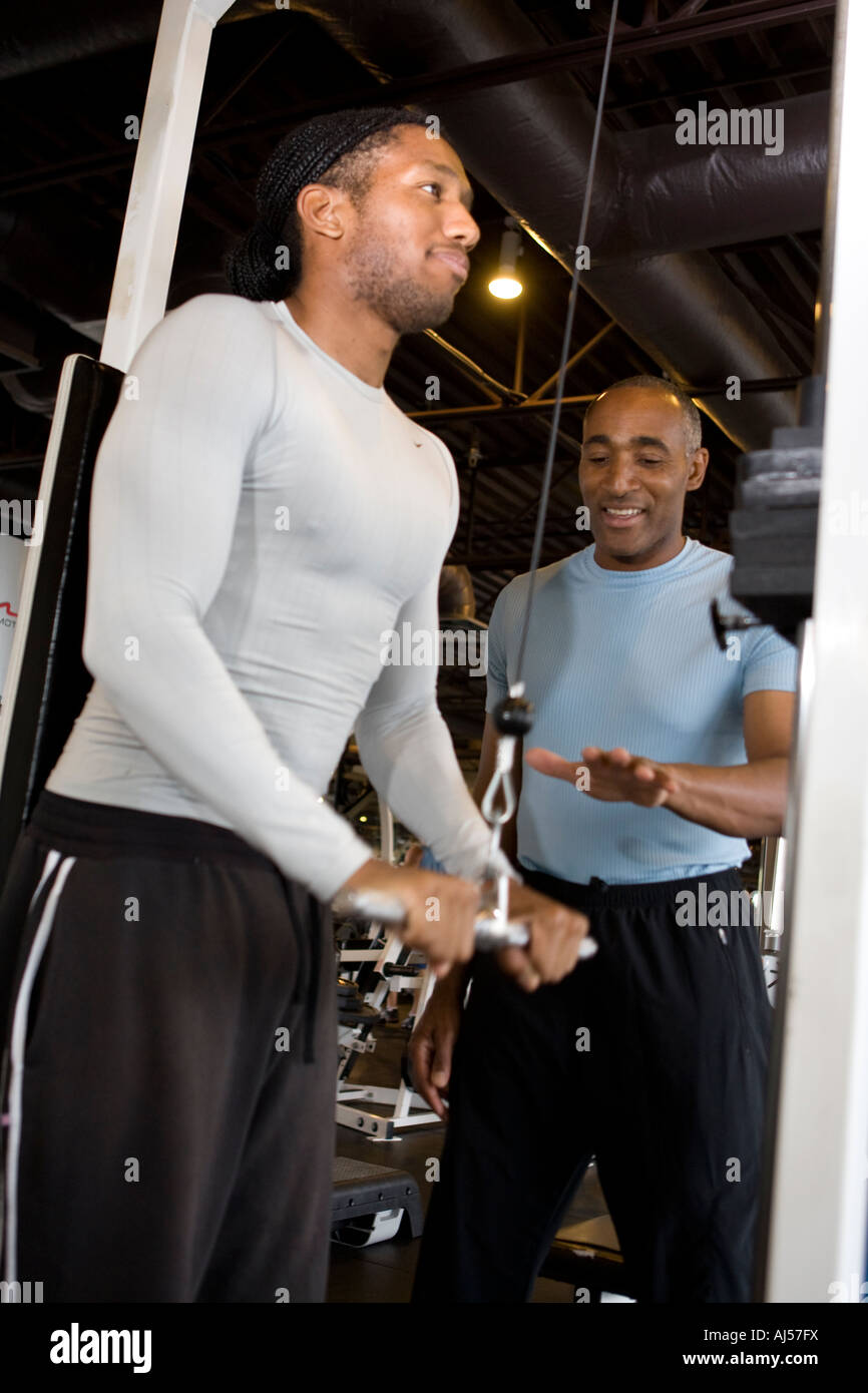 two 2 fit fitness males men exercising in a gym tricep workout Stock ...