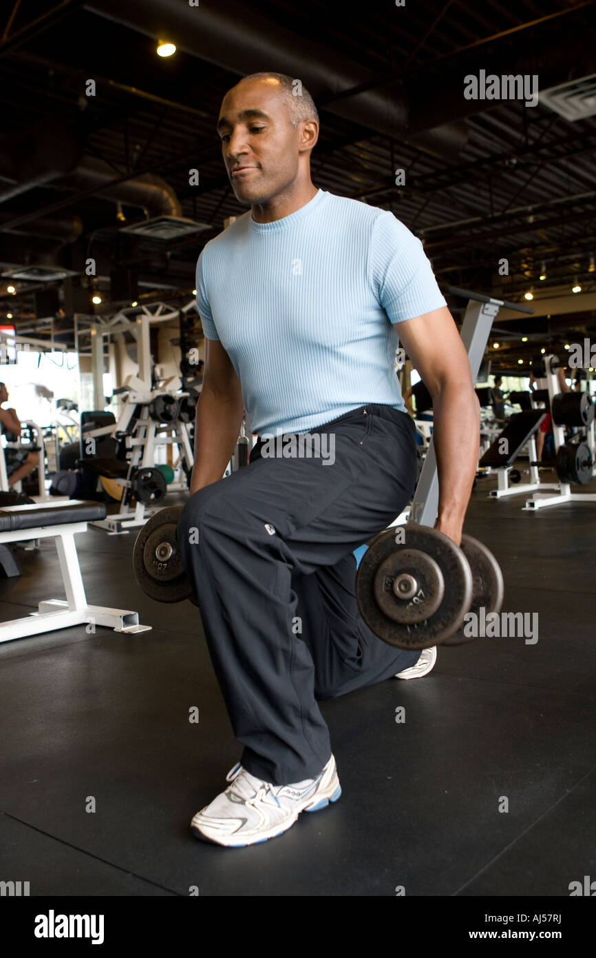 fit fitness male man exercising in a gym leg squat workout Stock Photo ...