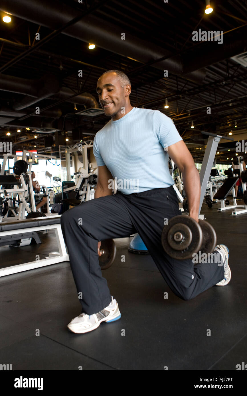 fit fitness male man exercising in a gym leg squat workout Stock Photo ...
