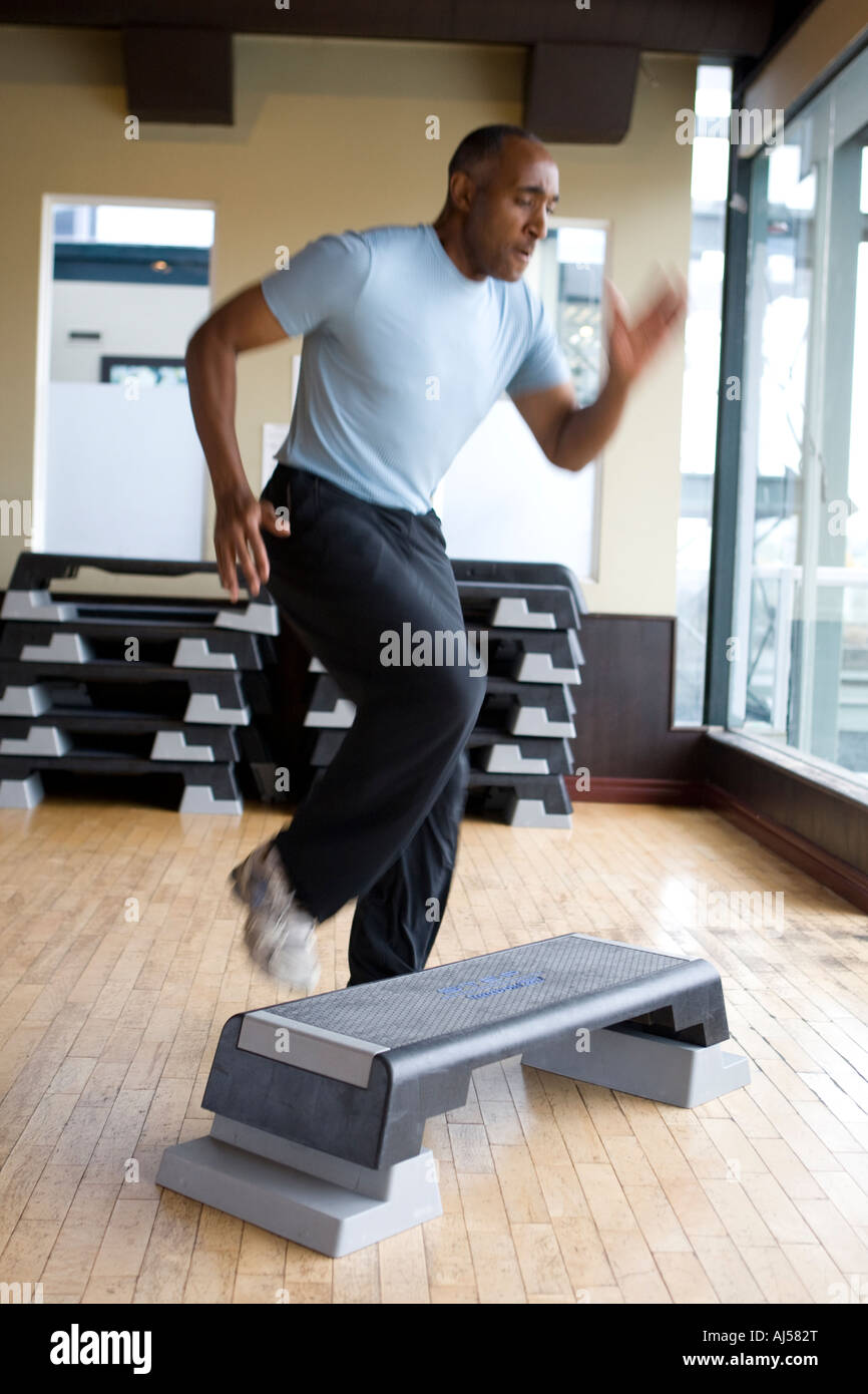 fit fitness male girl exercising in a gym jump step workout Stock Photo ...