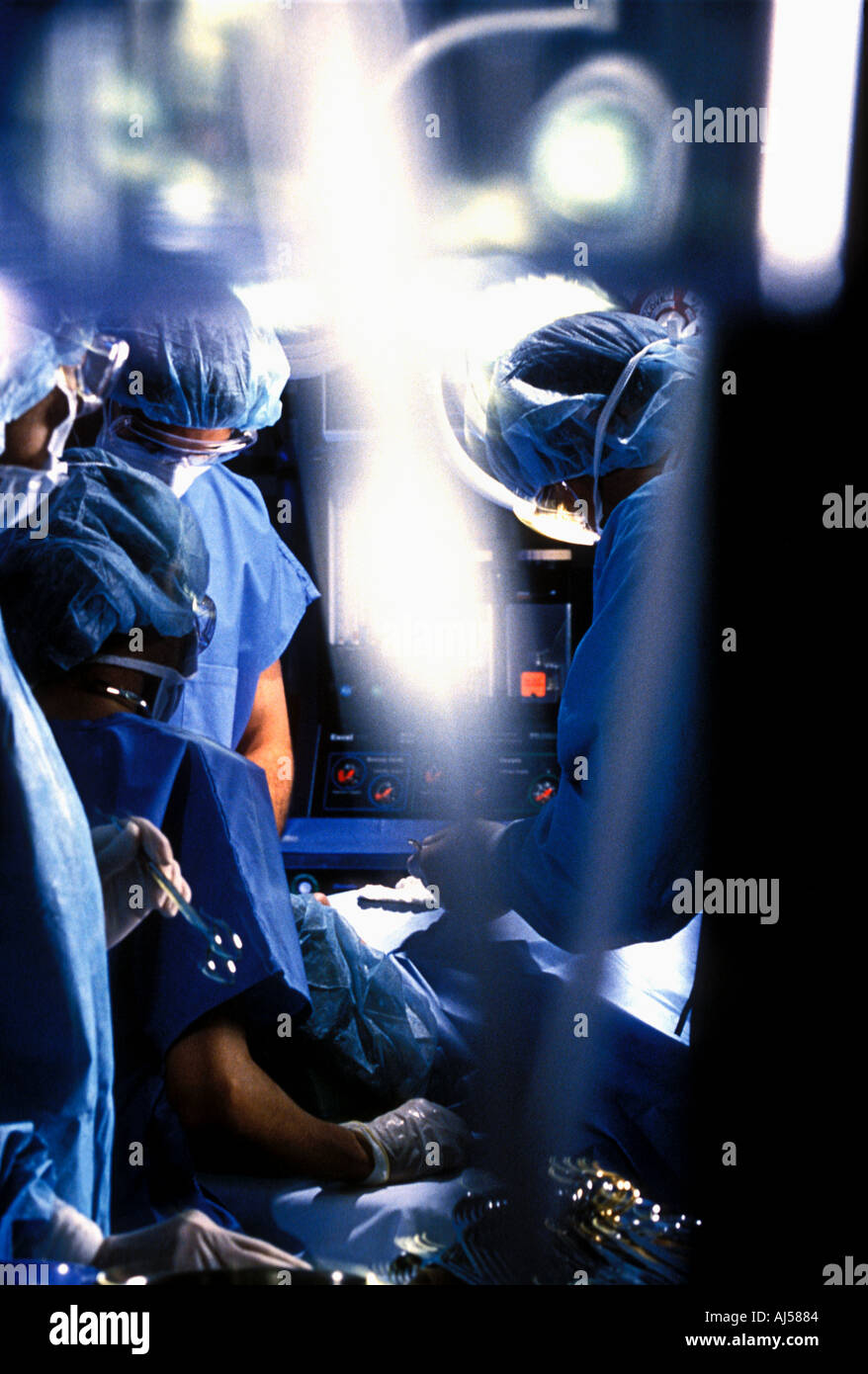 Surgical personnel operating on patient in operating room Stock Photo ...