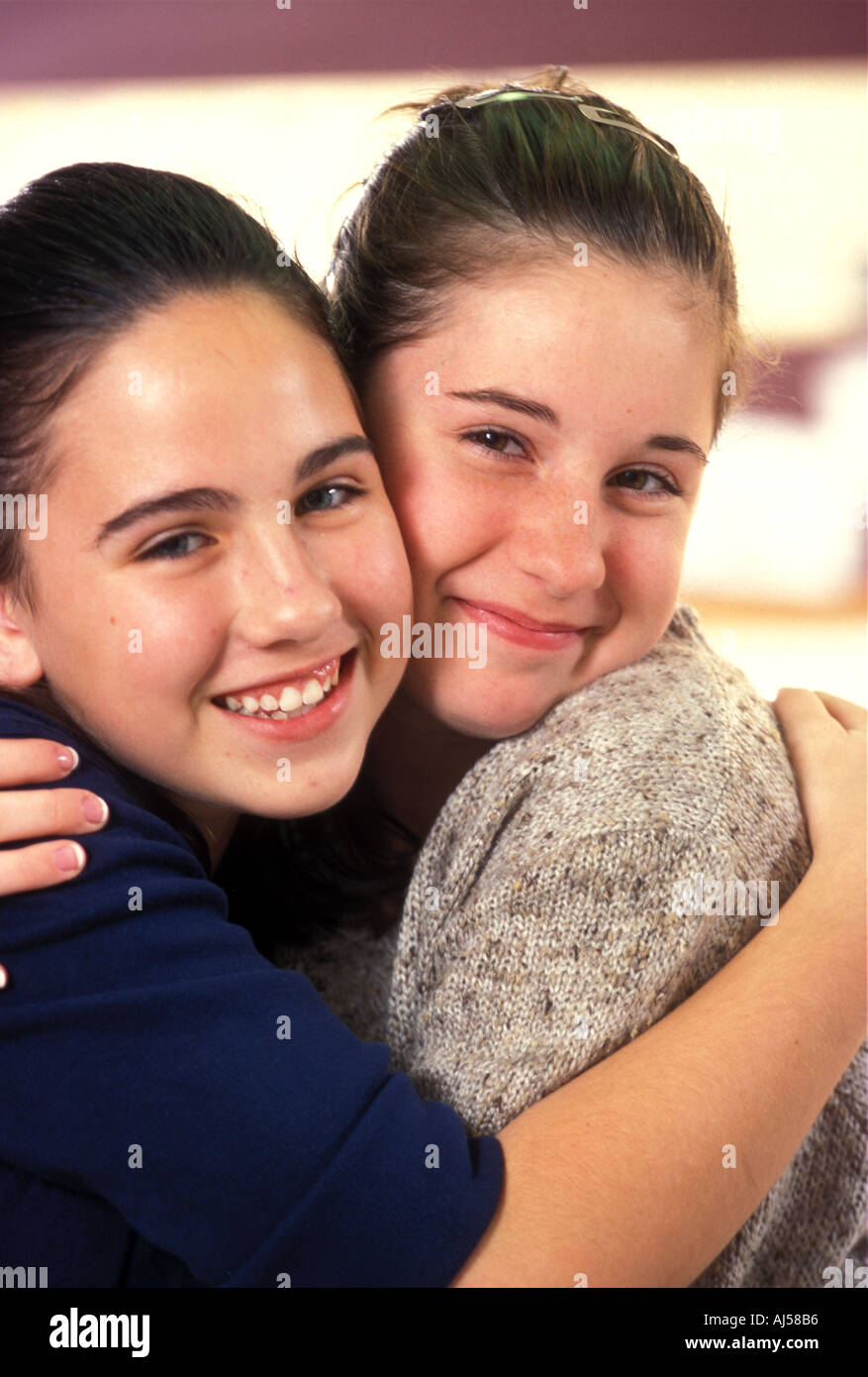 Female Teenage best friends hugging Stock Photo - Alamy