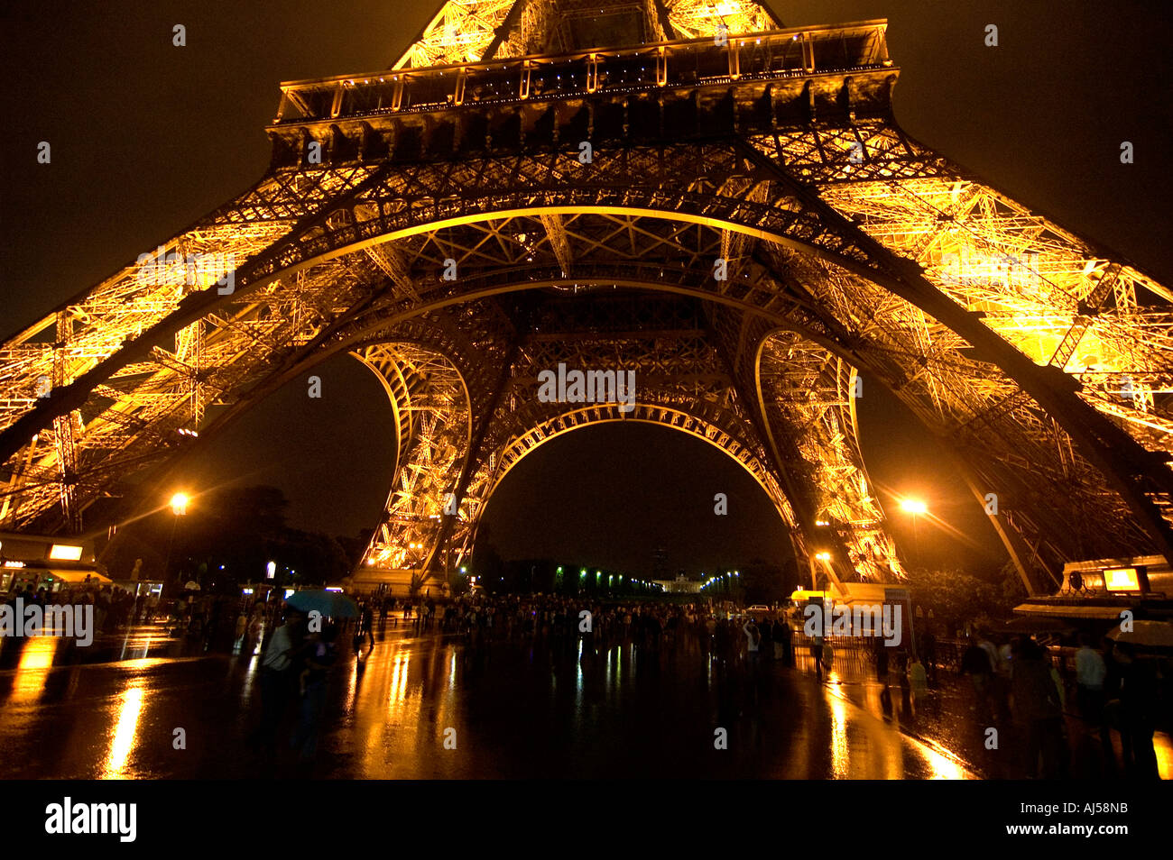 A wide angle shot of the Eiffel tower base feet reflected on the ground ...