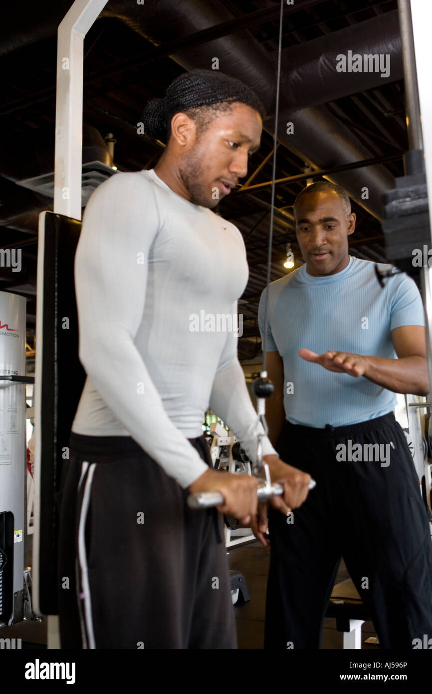 two 2 fit fitness males men exercising in a gym tricep workout Stock ...