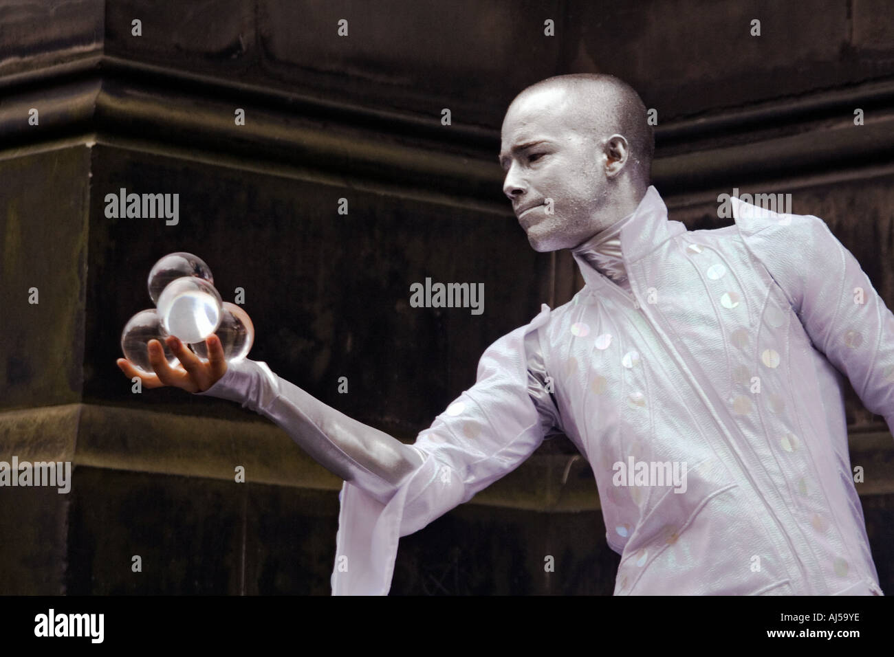 A fringe performer entertaining people with a show of contact juggling ...