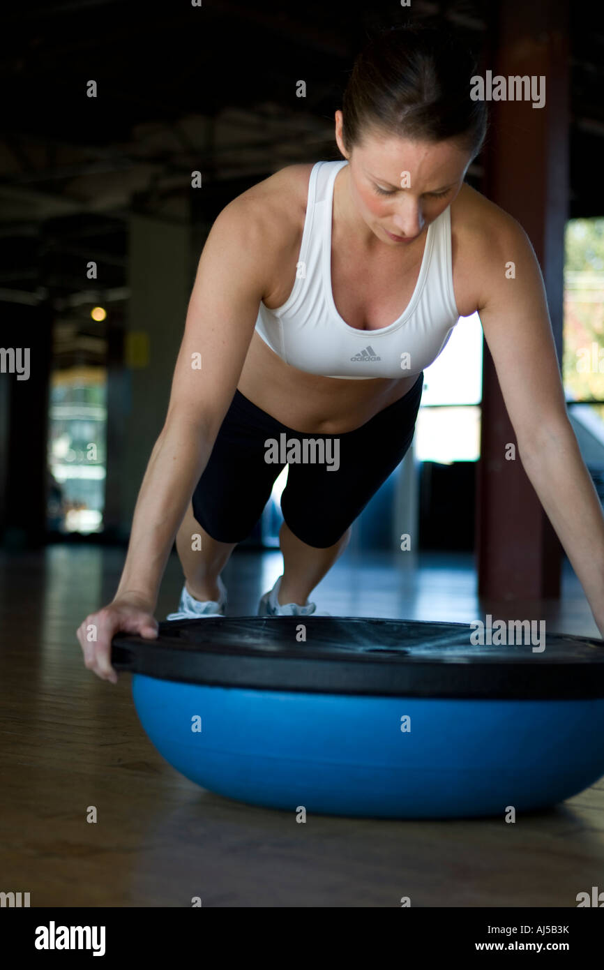 Fit female in great shape exercising in a gym aerobic bosu workout ...